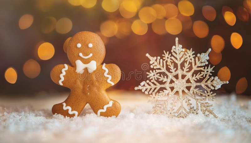 A Gingerbread Man and a Sparkly Silver Snowflake Sit on a Snowy Surface ...