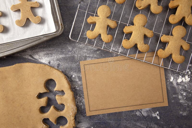 Gingerbread Men Being Made on a Dark Surface with a Blank Recipe Stock ...