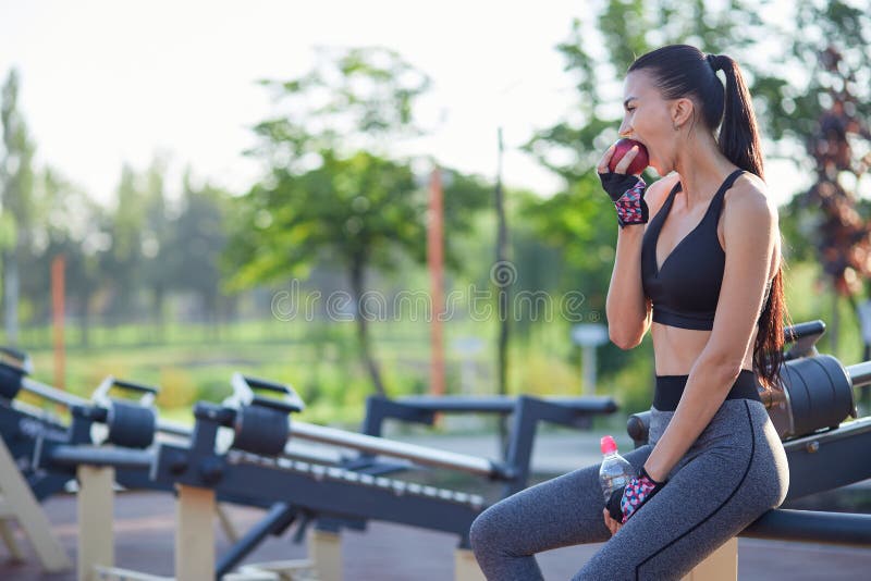 Girl Athlete Bites and Eats an Apple after a Workout Stock Photo ...