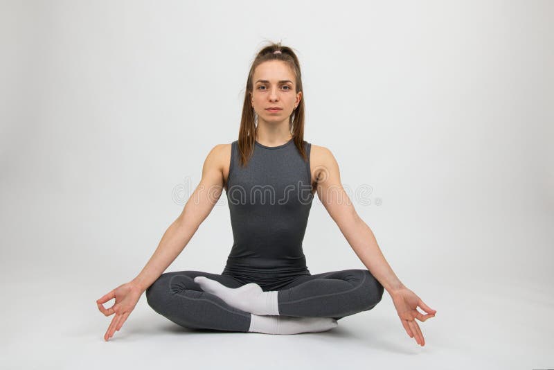 A Girl Athlete Does Yoga, Demonstrating the Exercises. Studio Shot ... A Girl Athlete Does Yoga, Demonstrating the Exercises. Studio Shot ...