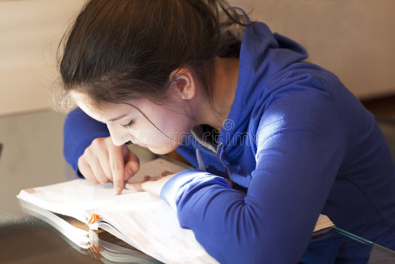 Girl Attentively Studying a Textbook Stock Photo - Image of teenager ...