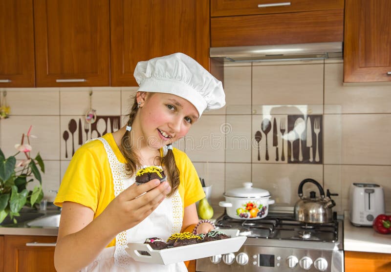 A Girl Baked a Cupcake in Her Kitchen Stock Photo - Image of bakery ...