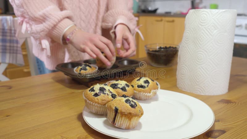 A Girl is Baking Blueberry Muffins in a Cozy Kitchen Stock Video ...