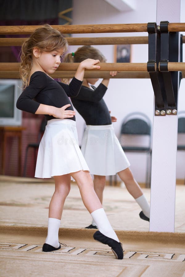 Little Girl Poses at Ballet Barre Stock Photo - Image of child, dancer ...