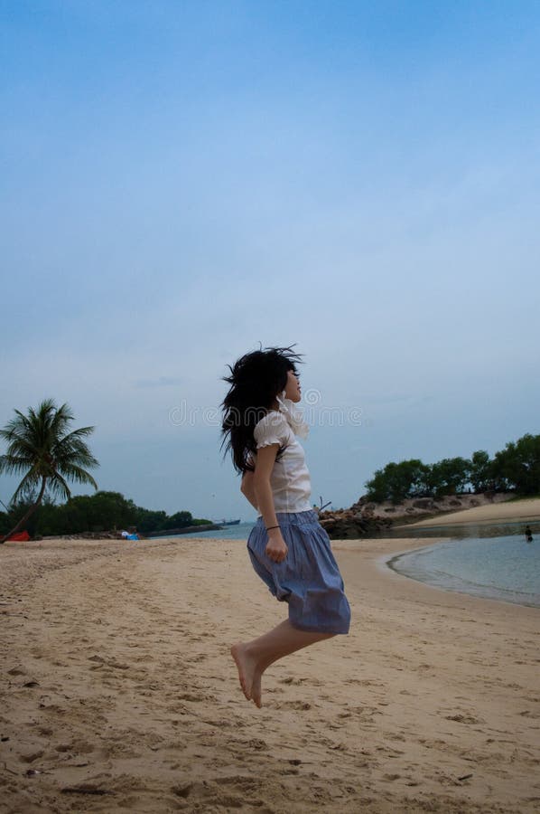 Girl on Beach and Jump stock photo. Image of legs, holiday - 10902228