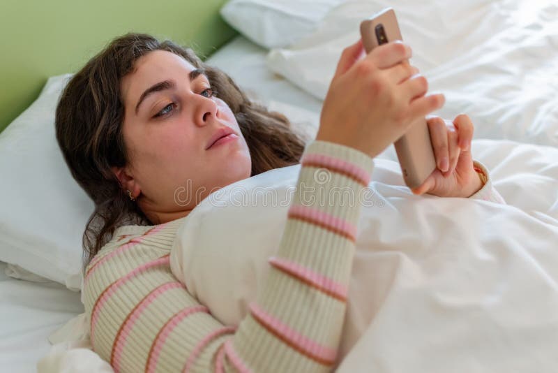Girl in a Bed Checking Her Phone Stock Image - Image of sleep, rest ...