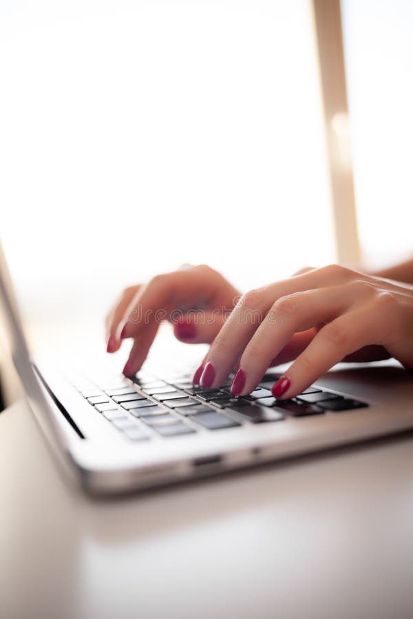 The Girl Behind The Laptop Female Hands Typing Text On The Keyboard