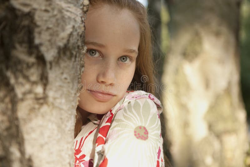 Girl behind Tree in Forest stock photo. Image of nature - 24686534