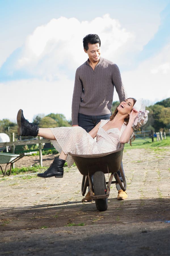 Girl Being Pushed Wheelbarrow Man Stock Photos - Free & Royalty-Free ...