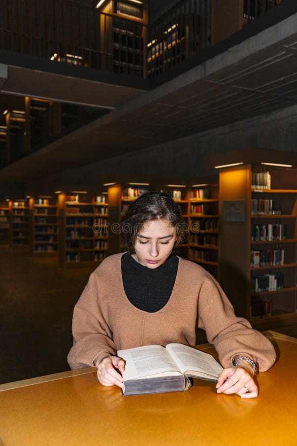 Girl Bent Over Book Sitting in Library Alone Stock Image - Image of ...