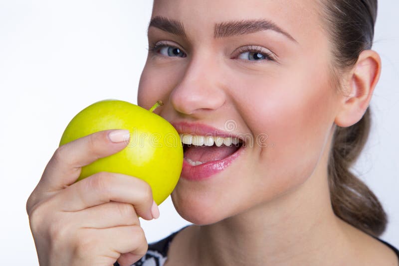 Girl biting an apple stock image. Image of fresh, attractive - 101285329