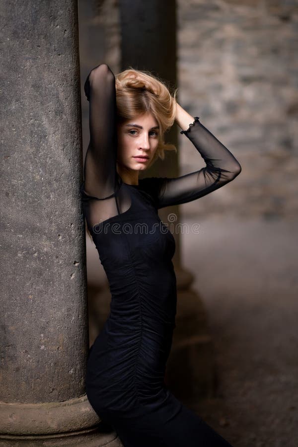 Girl in Black Dress Leaning on a Column Stock Photo - Image of ...