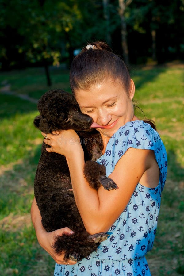 Girl with black poodle stock image. Image of curly, pets - 77354529