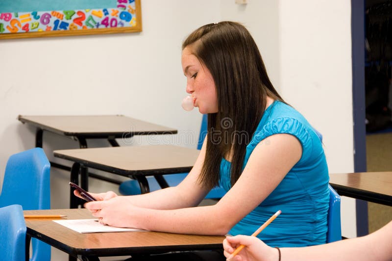 Girl Blowing Bubble and Texting in Class Stock Image - Image of looking ...