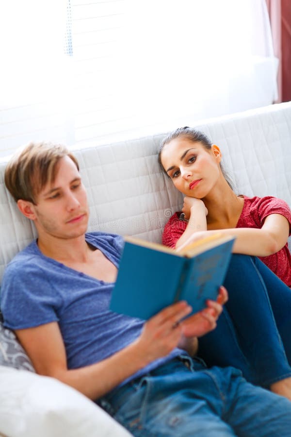 Girl Boring while Her Boyfriend Reading Book Stock Image - Image of ...