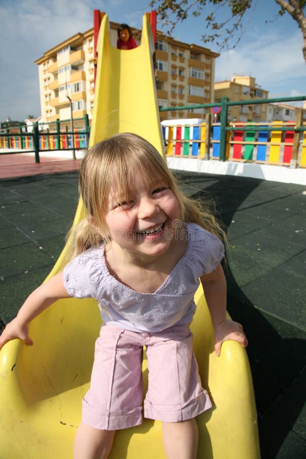 Girl at bottom of slide stock photo. Image of playground - 2248300