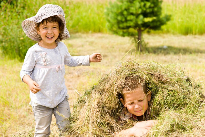 Girl and boy and hay stock image. Image of resting, smiling - 20243557