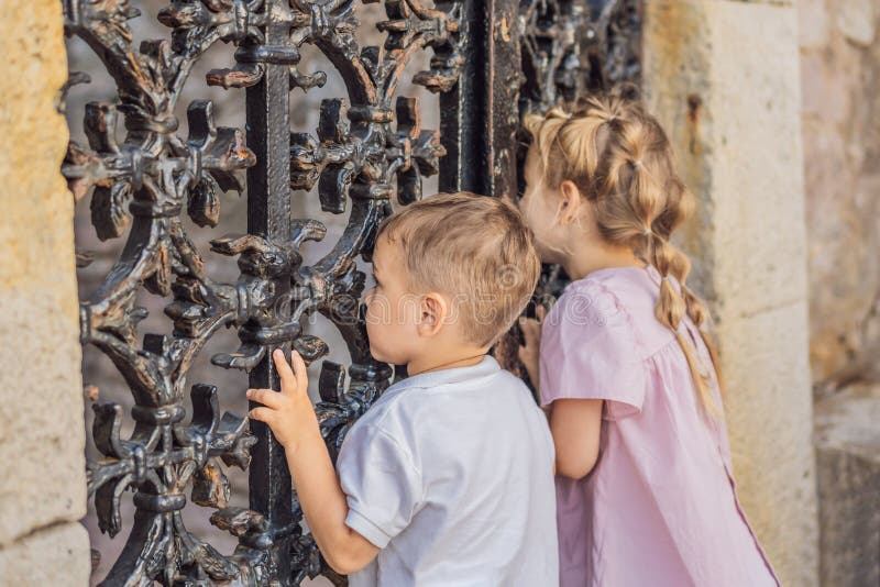 Girl and Boy Peeking Over the Fence Stock Image - Image of game ...