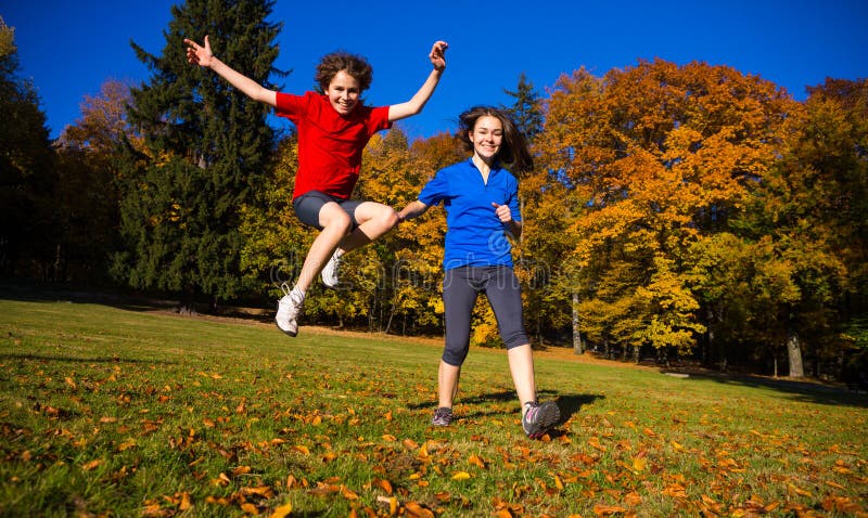 Girl and Boy Running, Jumping in Park Stock Photo - Image of kids ...
