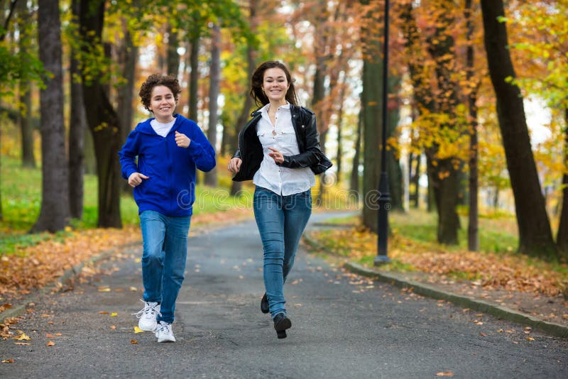 Girl and Boy Running, Jumping in Park Stock Photo - Image of jump ...