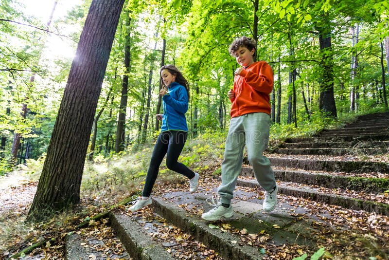 Girl and Boy Running, Jumping in Park Stock Photo - Image of jogging ...