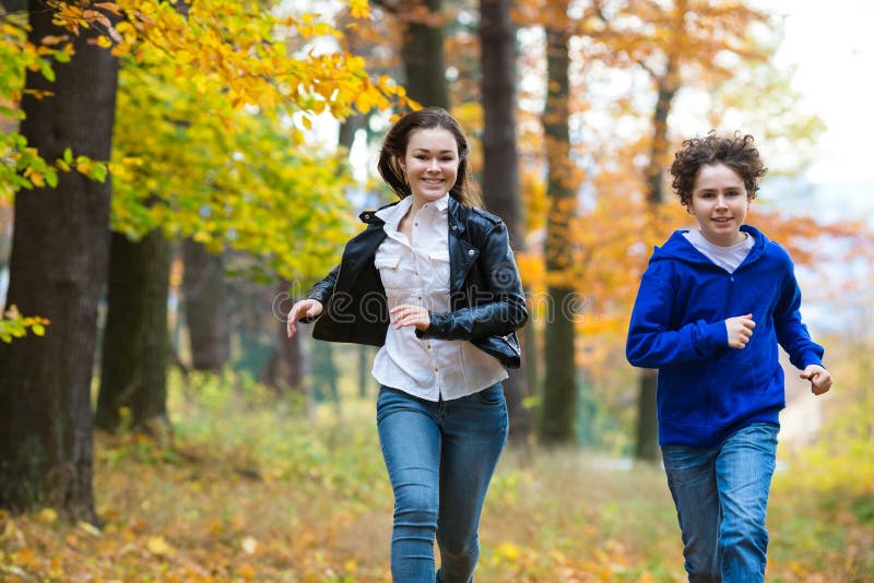 Girl and Boy Running, Jumping in Park Stock Image - Image of horizontal ...