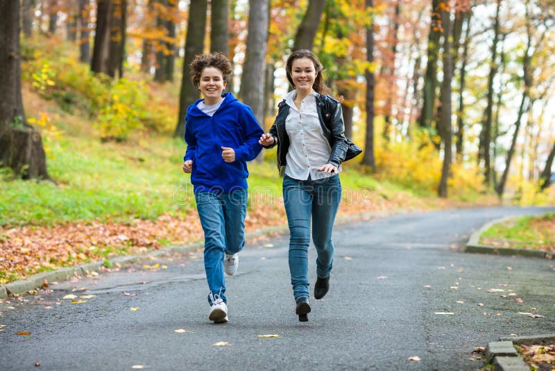 Girl and Boy Running, Jumping in Park Stock Image - Image of playful ...