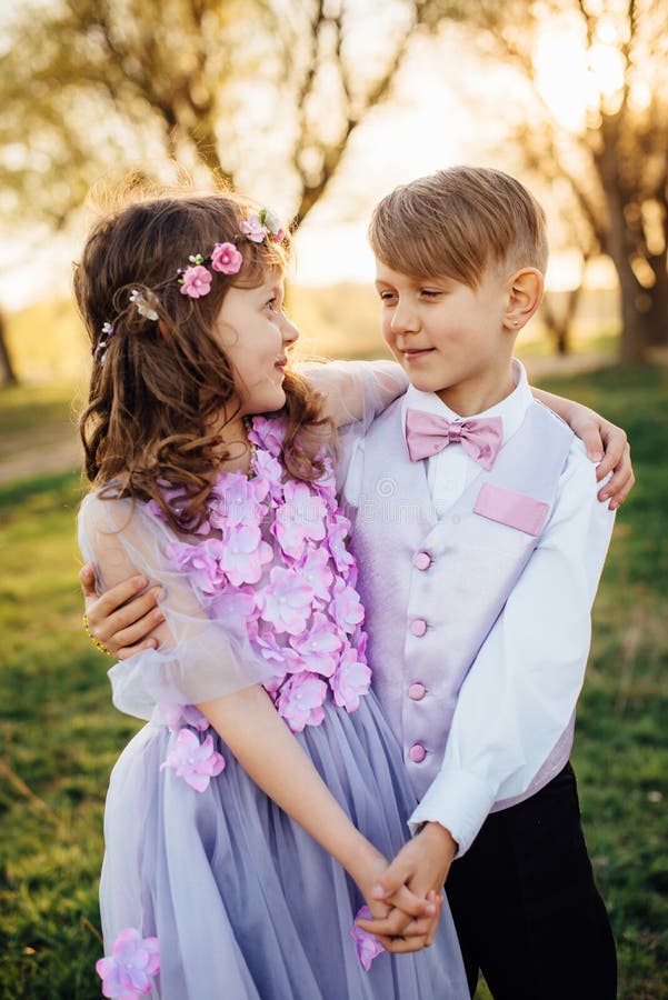 A Girl and a Boy in Smart Clothes are Walking in the Park Stock Photo ...