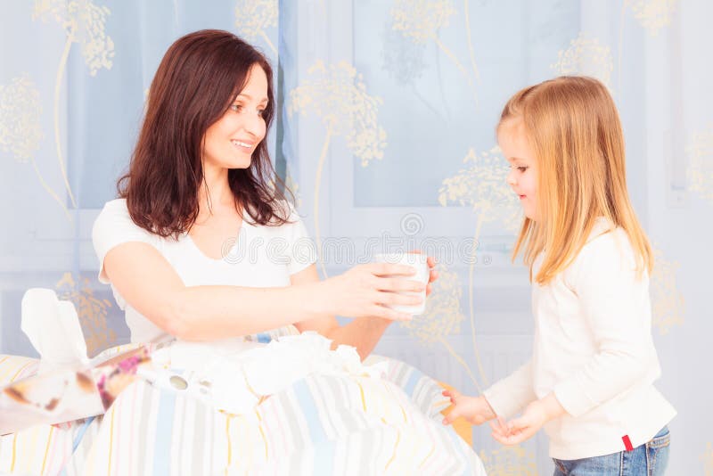 Girl Bringing Her Mom a Cup of Tea Stock Image - Image of woman, caring ...