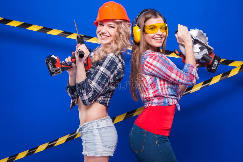 Girl Builder in the Construction Helmet and Goggles with a Construction ...
