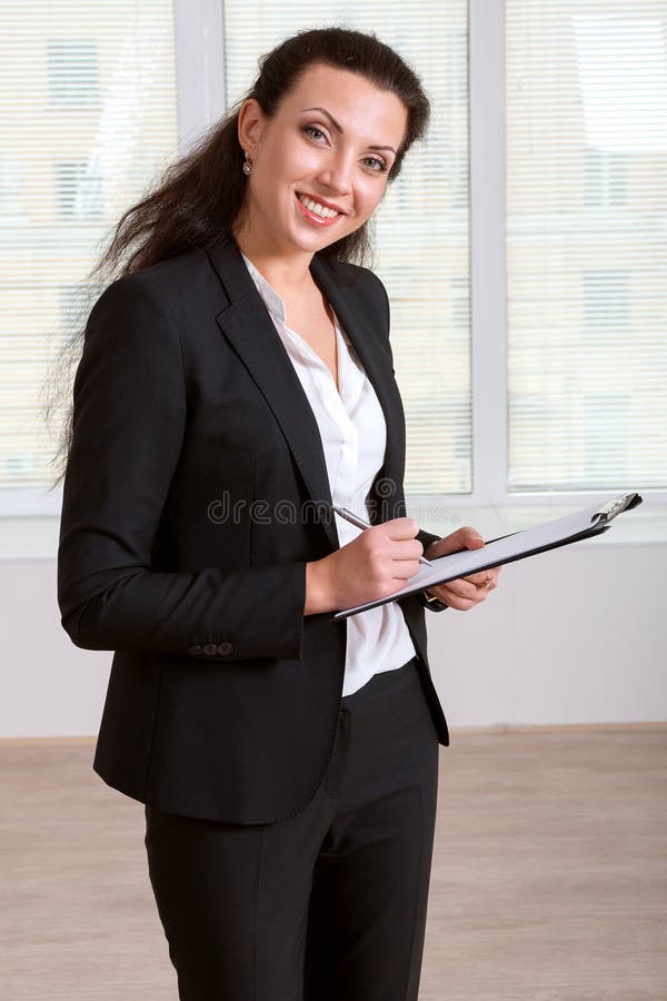 Girl in Business Suit Writing in a Document Folder Stock Photo - Image ...