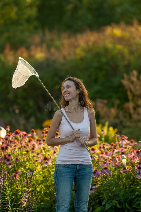 Girl with butterfly net stock photo. Image of landing - 75941350