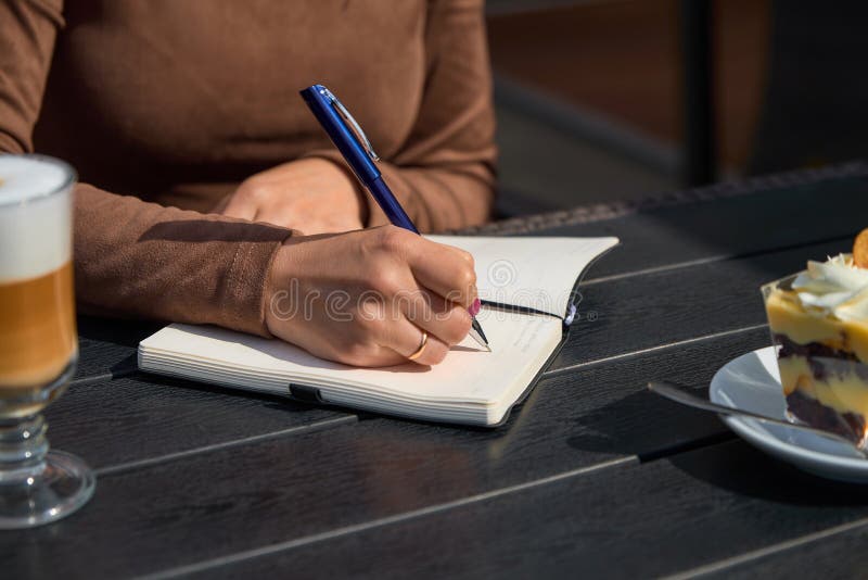 A Girl in Cafe Writes in a Notebook Stock Image - Image of notepad ...