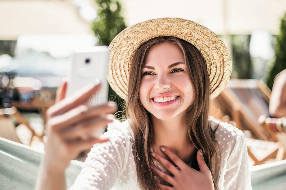 Girl Calling by Videoconference while Sitting on the Beach in Summer in ...