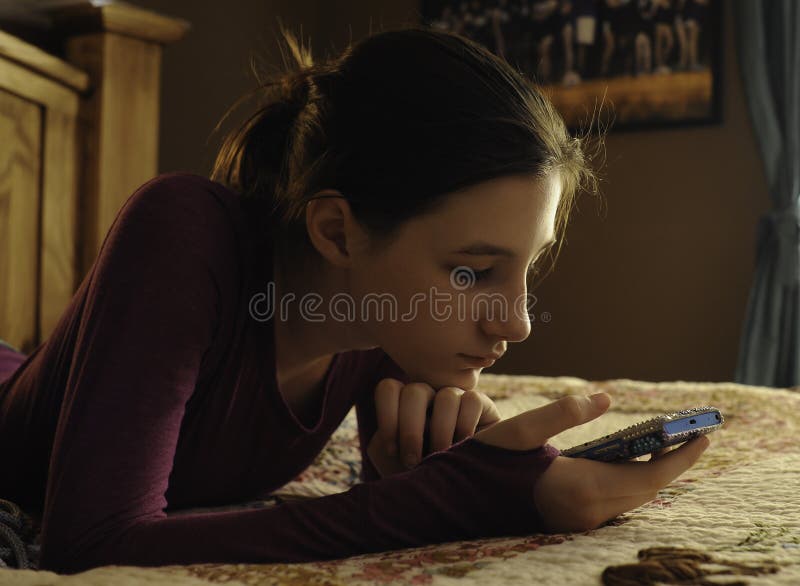 Girl with cell phone stock image. Image of teen, bedroom - 27748827