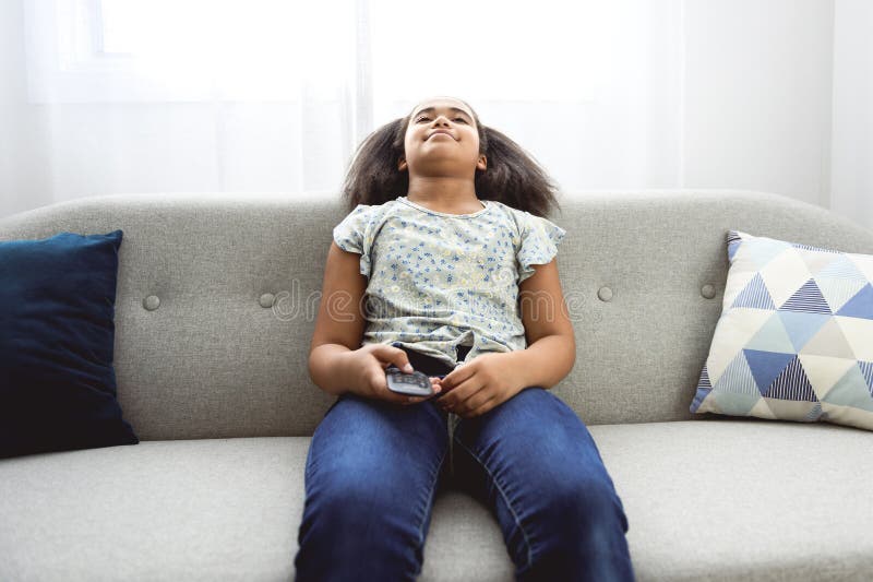Girl Changing Channel with Remote Control in Front of Television at ...