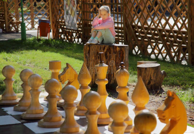 Girl playing big chess set stock image. Image of winner - 194757