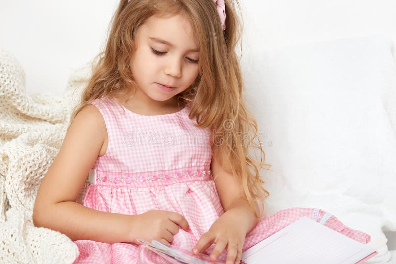 Girl Child Rad Book in Bed, Dressed in Pink Stock Photo - Image of head ...
