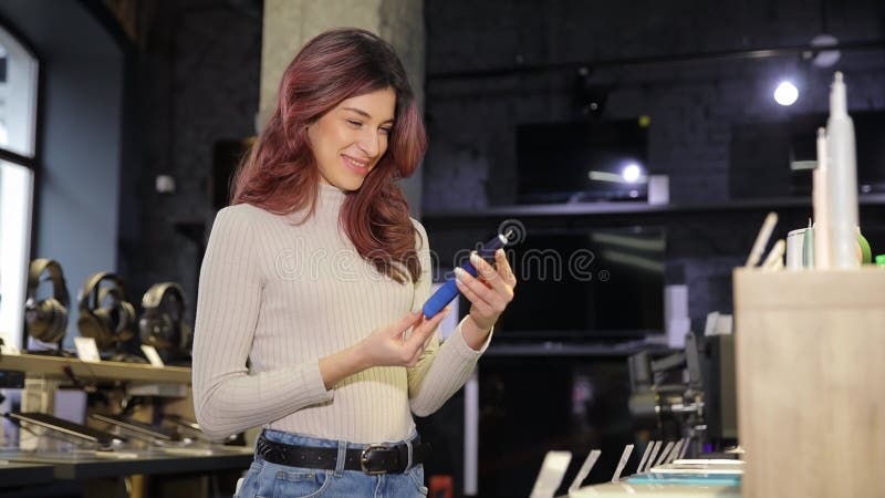 A Girl Chooses a Nose Trimmer in a Hardware Store Stock Video - Video ...