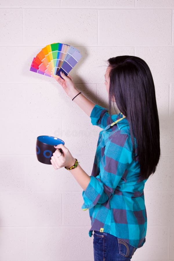 Girl Choosing a Color for the Walls Stock Photo - Image of paintbrush ...