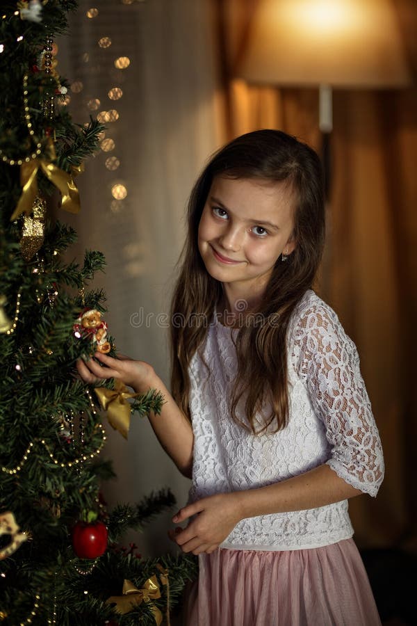 Girl at the Christmas Tree in the Evening of Christmas Stock Photo ...