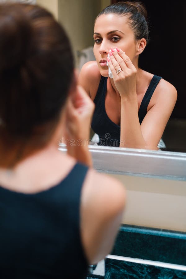 Girl Cleaning Makeup with a Tissue in the Bathroom Stock Image - Image ...