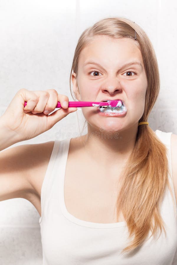 Girl is cleaning teeth stock photo. Image of angry, health - 26843292