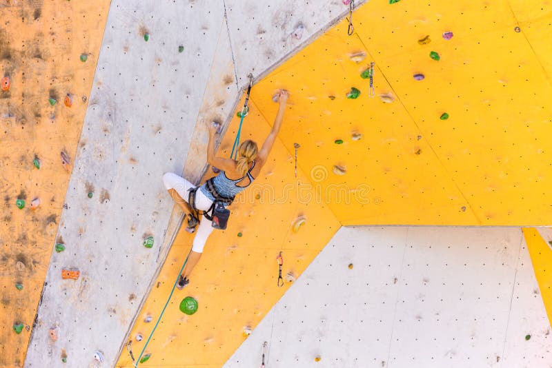 Girl climbing up the wall stock image. Image of exercise - 134441181