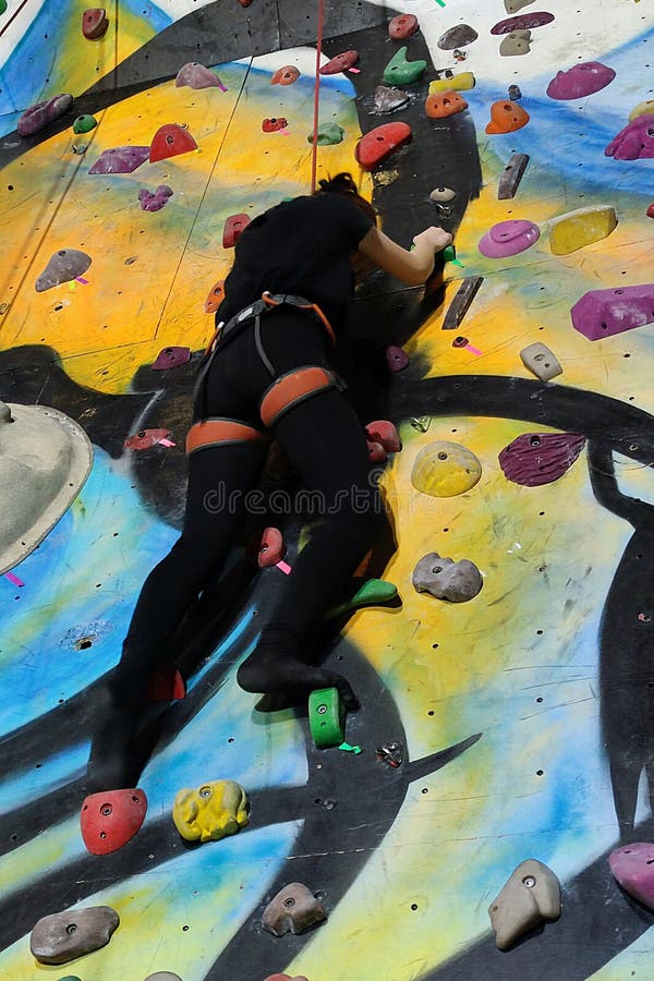 Girl Climbing Up the Wall of the Training Climbing Wall Stock Photo ...