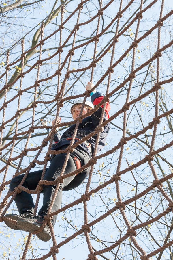 The Girl Climbs Obstacles of Rope Park Stock Image - Image of high ...