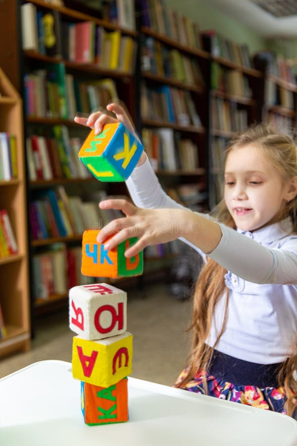 Girl Collects Alphabet Cubes into Stack Stock Photo - Image of reading ...