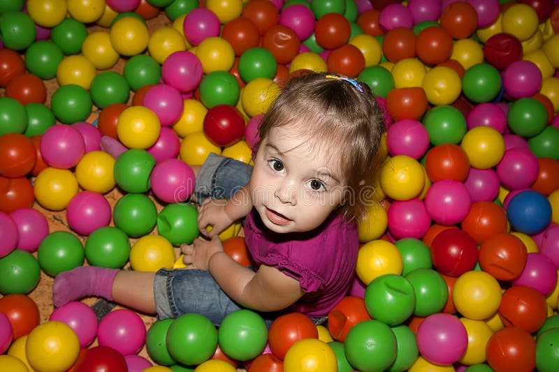 Happy girl in ball pool stock photo. Image of entertainment - 14521792