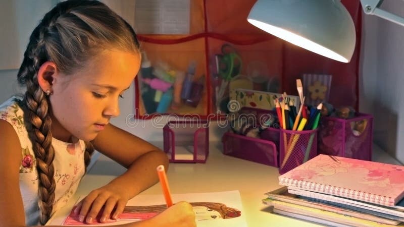Girl Coloring Her Drawing at the Desk in the Evening Stock Footage ...