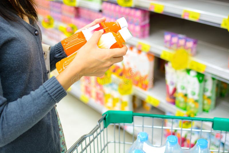 Girl Comparing in Supermarket Stock Image - Image of shelf, department ...